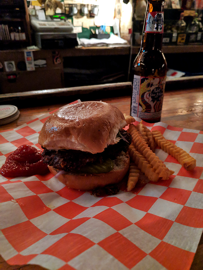 The cheeseburger arrives like a beautiful mess of a friend who always makes the night memorable, with crispy fries standing by for support.