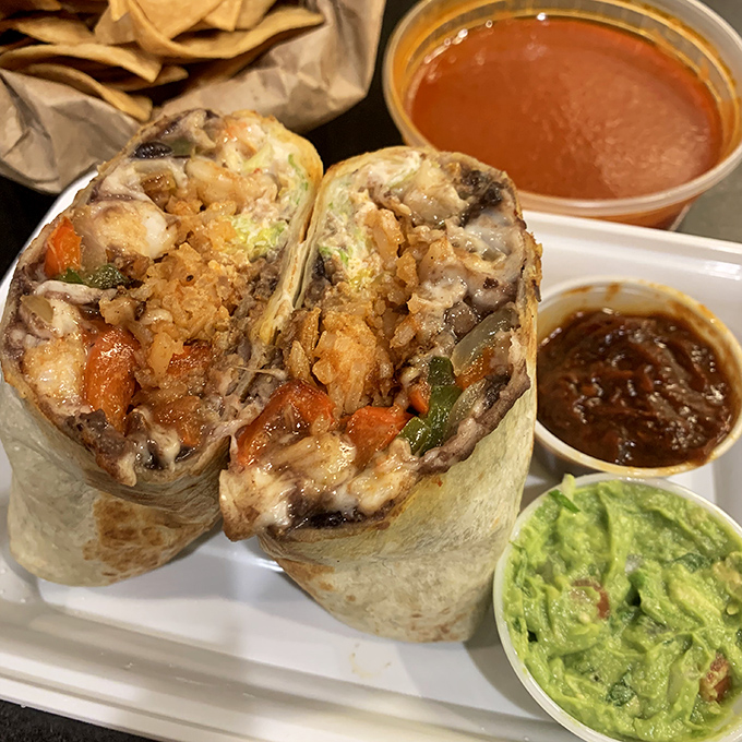 The perfect plate: seasoned meat, vibrant veggies, rice that's absorbed all the right flavors, and beans that deserve their own fan club.