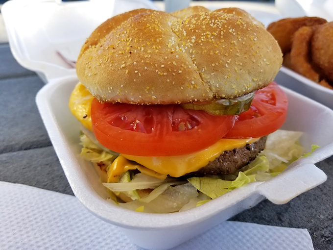 This isn't just a cheeseburger&mdash;it's edible architecture. Fresh tomato, melty cheese, and a perfectly toasted bun create the holy trinity of burger perfection.