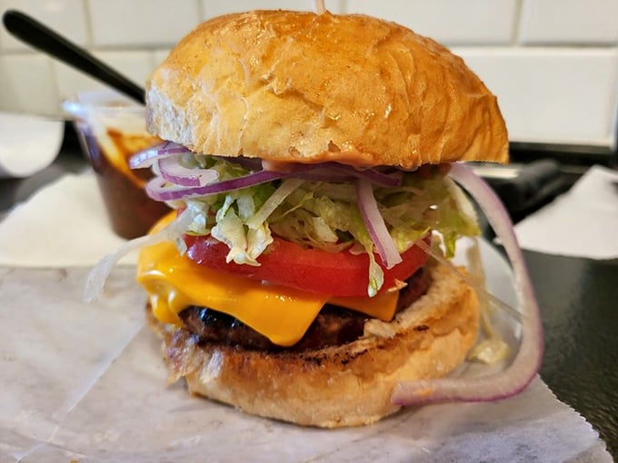 This isn't just a cheeseburger; it's architecture. The golden cheese cascade and fresh toppings create the Taj Mahal of handheld delights.