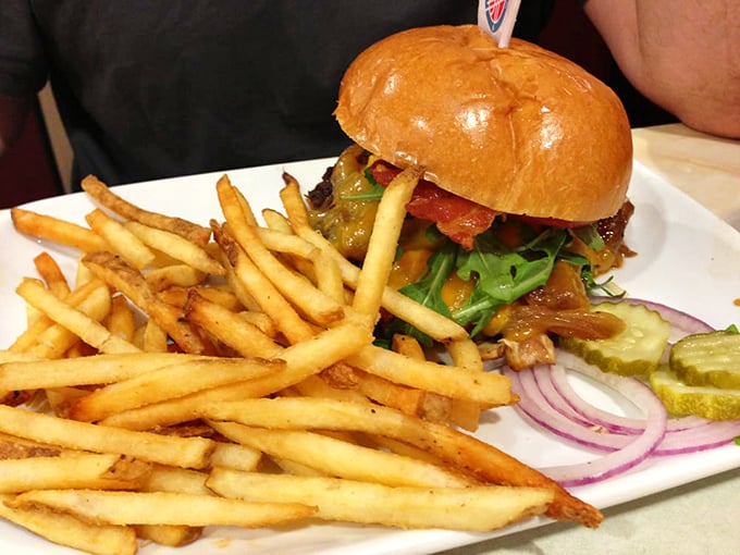 This isn't just a burger—it's edible architecture. The perfect stack of beef, bacon, and fresh veggies creates a skyscraper of flavor worth every napkin.