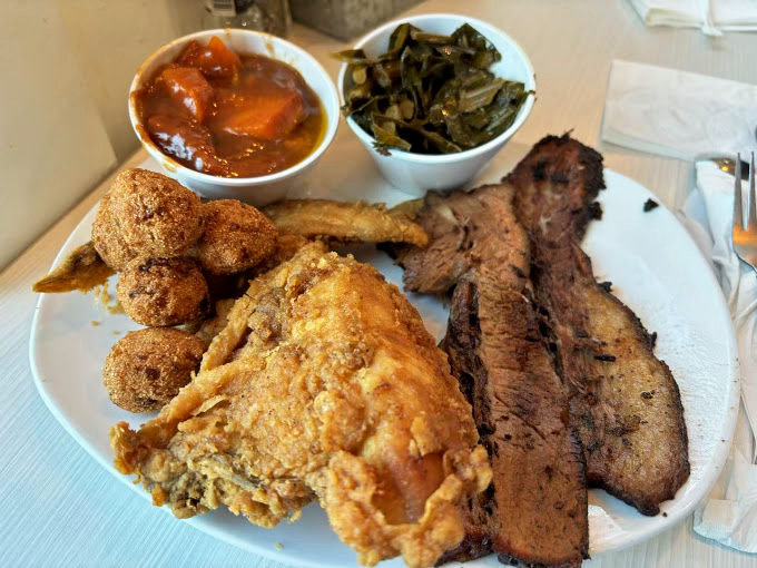 Southern comfort on a plate: golden fried chicken, savory brisket, and sides that make vegetables worth eating. Diet plans come here to die happy deaths.