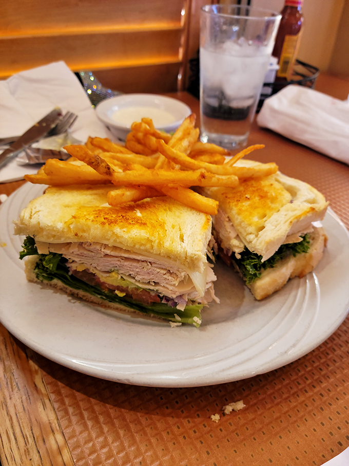 This isn't just a sandwich—it's architecture with purpose. Layers of flavor stacked between perfectly toasted bread with fries that demand equal attention.