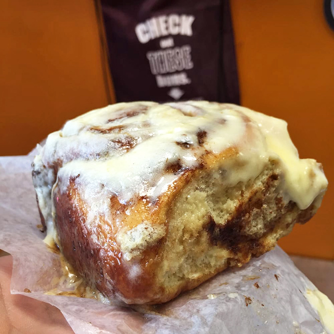 This isn't just a cinnamon roll; it's an architectural marvel of spiraled dough and cream cheese frosting that makes diets spontaneously combust.