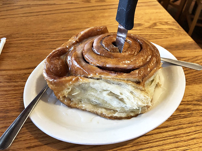 The mythical cinnamon roll in its natural habitat. Note how the knife attempts to tame it, yet struggles against its magnificent girth.