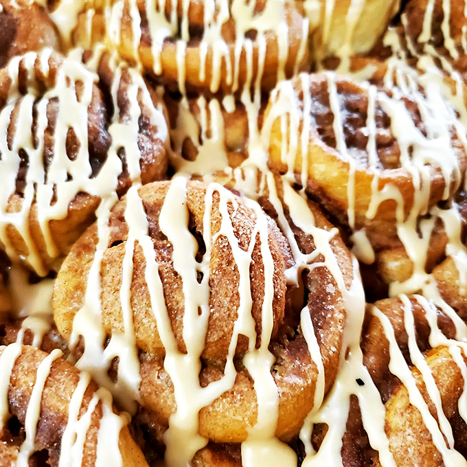 These cinnamon rolls aren't just breakfast&mdash;they're an event, with cream cheese frosting cascading down spiral layers of spiced perfection.