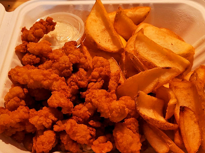 Golden-brown clam strips that crunch like nature's potato chips from the sea, paired with fries that didn't come from a freezer.