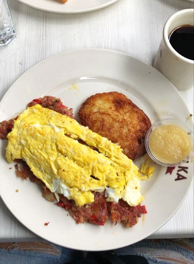Breakfast nirvana found: Fluffy scrambled eggs atop perfectly crisped corned beef hash with a golden potato pancake sidekick. Morning hunger doesn't stand a chance.
