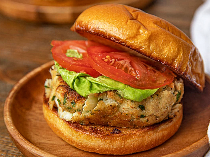 The star of the show: a golden-brown crab cake sandwich bursting with lump meat, barely held together by kitchen wizardry and good intentions.