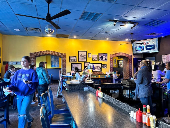 Yellow walls and brick accents create a sunny backdrop for the morning ritual&mdash;a space where coffee flows and conversation follows.