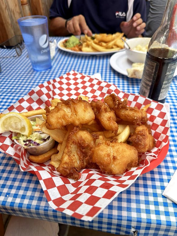 Golden-battered cod chunks that shatter with each bite, nestled alongside crispy fries—proof that simplicity, when done right, is culinary poetry.