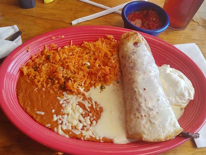 A classic Mexican trinity&mdash;refried beans, Spanish rice, and a burrito so plump it deserves its own zip code. That cheese pull alone justifies the drive.