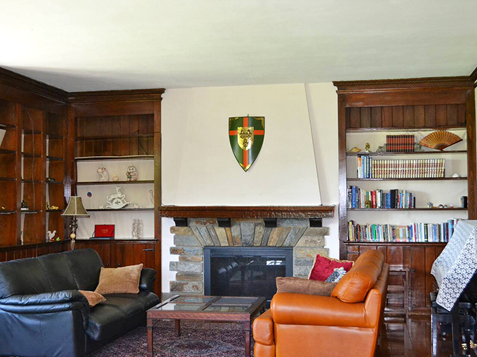 The family room's stone fireplace and heraldic shield create a space where Game of Thrones meets modern family game night.