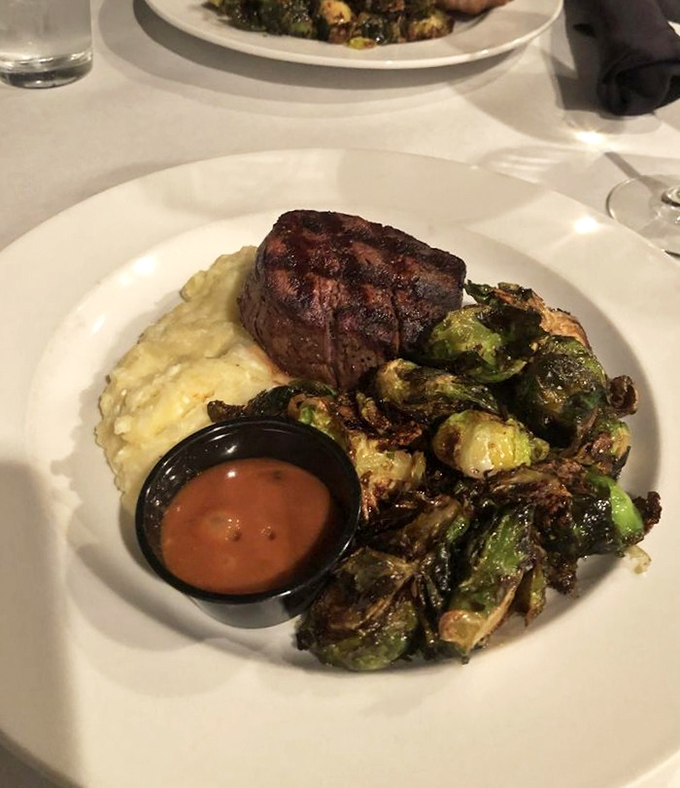 This filet mignon isn't just a steak; it's a meditation on perfection. The mashed potatoes and brussels sprouts aren't sides—they're worthy companions on a flavor journey.