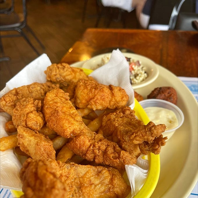 Golden-battered fish perched atop a mountain of fries &ndash; this isn't just fish and chips, it's edible architecture with a side of happiness.
