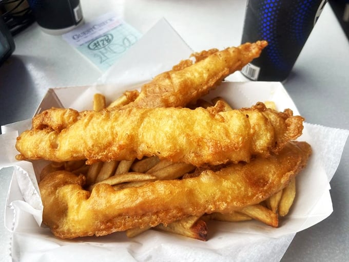 Golden-battered fish fillets lounging atop a bed of crispy fries&mdash;the culinary equivalent of a perfect day at the beach.
