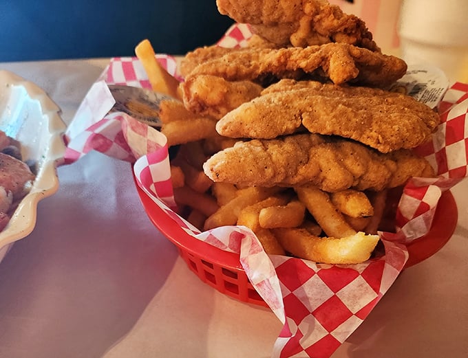Golden-fried fish perched atop a mountain of crispy fries&mdash;proof that sometimes the simplest combinations make the most profound statements.
