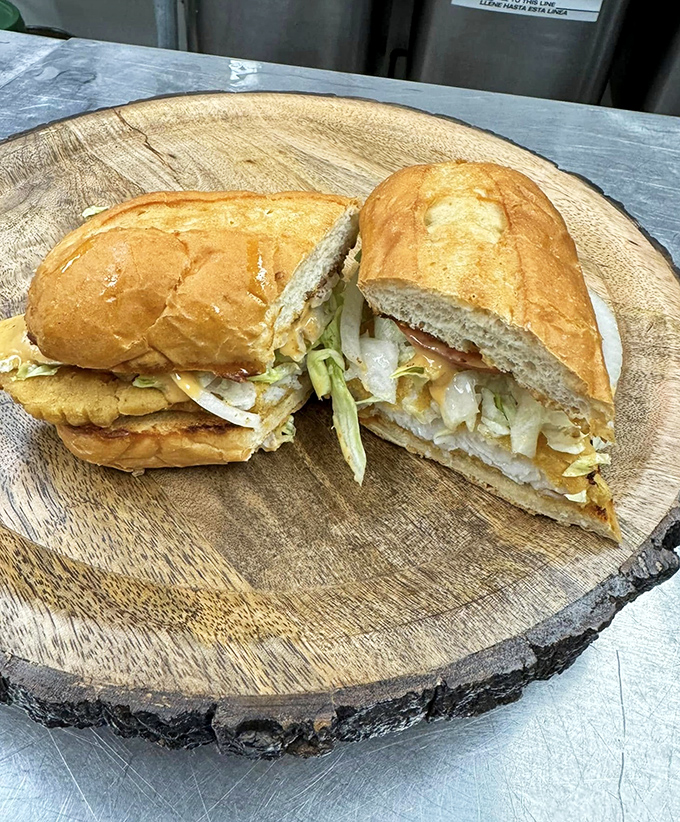 The legendary fish sandwich in all its glory—a golden-battered masterpiece spilling over its bun borders like a delicious rebellion against portion control.