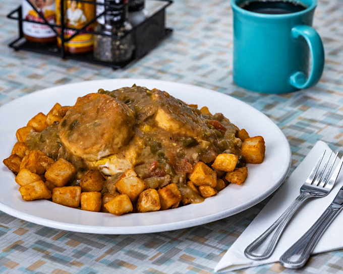 Behold: the breakfast of champions. Golden potatoes swimming in savory green chile with a perfectly cooked biscuit&mdash;this is what airport food courts dream of becoming.