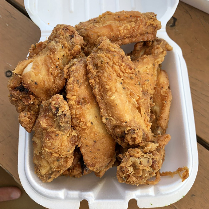 Golden-brown fried chicken wings that make Colonel Sanders look like he's still in basic training. Crispy, seasoned perfection worth every minute in line.