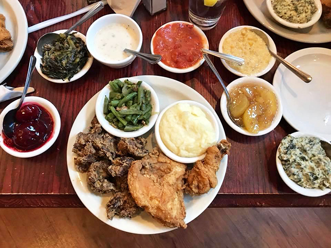 Southern abundance in its purest form: golden-fried chicken surrounded by a constellation of sides, each small bowl offering its own delicious universe.