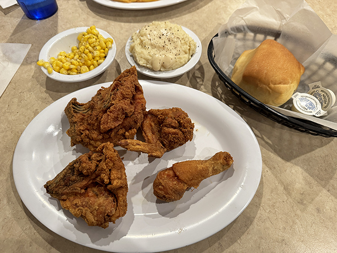 Golden-brown fried chicken that crackles with each bite, paired with buttered corn and mashed potatoes&mdash;a trio that's practically poetry on a plate.
