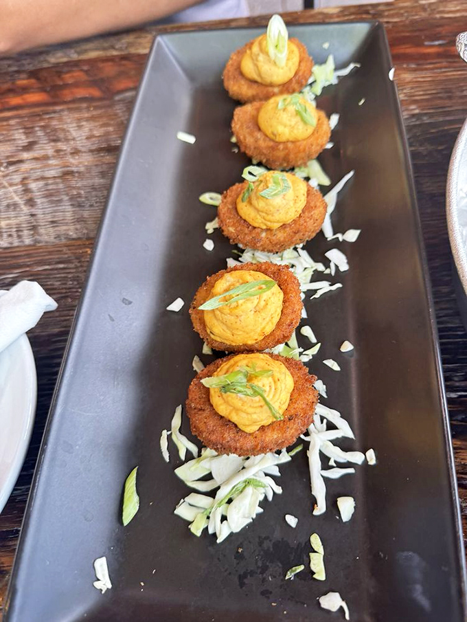 These aren't your aunt's potluck deviled eggs. Fried to golden perfection and topped with vibrant filling, they're worthy of their legendary status.