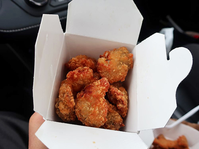 Golden-fried perfection in a humble white box. These crispy morsels deliver a satisfying crunch before melting into sweet, briny bliss.