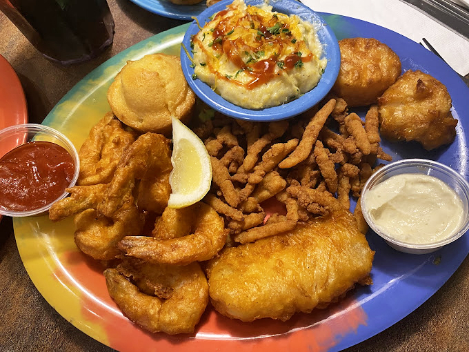 A seafood platter that would make Neptune himself put down his trident and pick up a fork. Golden-fried treasures nestled beside creamy sides.