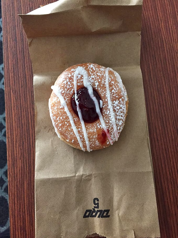 This powdered beauty with its ruby heart isn't just a donut&mdash;it's breakfast dessert poetry that speaks the universal language of "just one more bite."