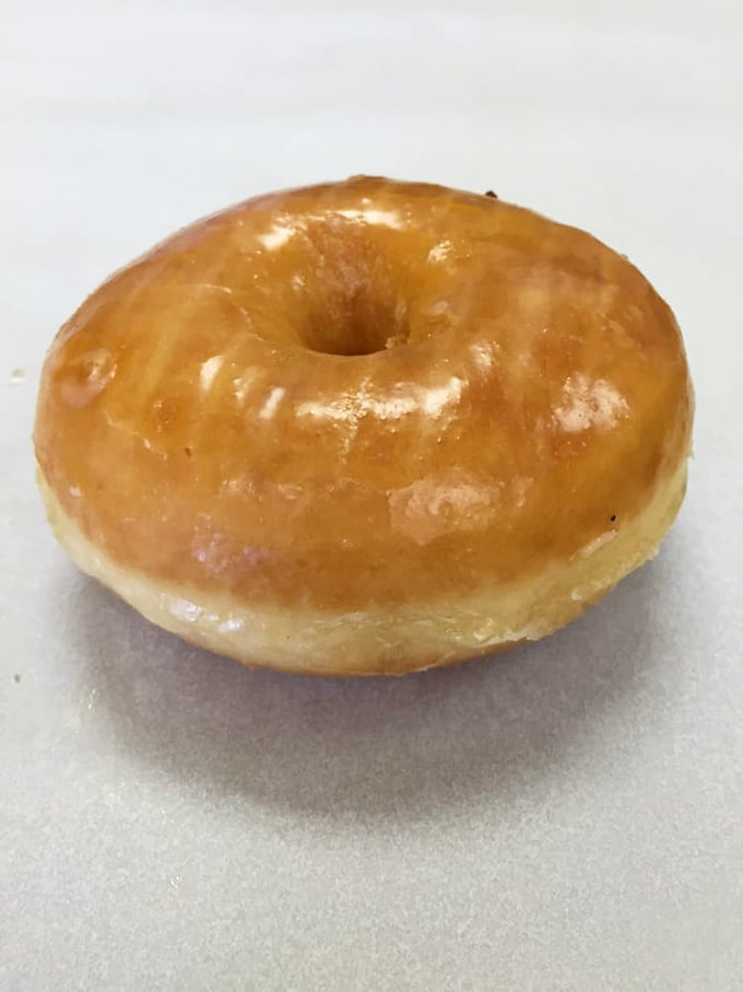 Behold perfection in circular form! This glazed masterpiece has the ideal sheen-to-dough ratio that donut dreams are made of.