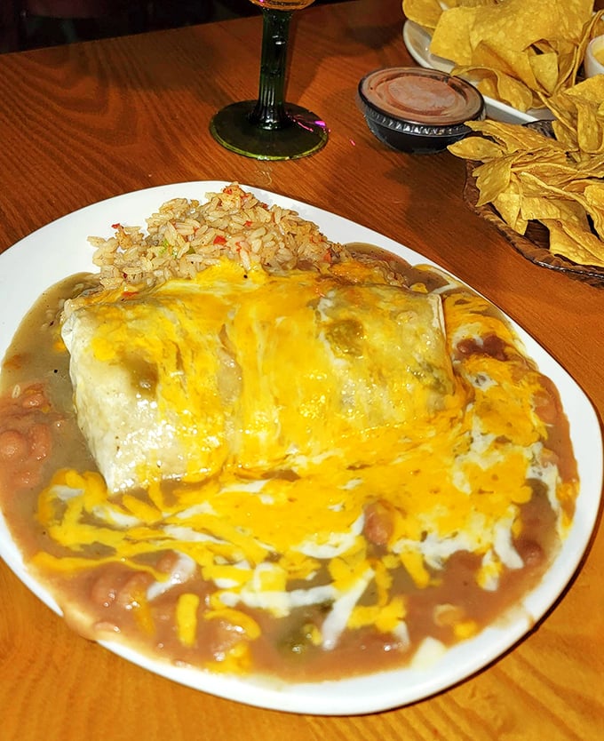 This isn't just a burrito&mdash;it's a golden-hued landscape of melted cheese and savory sauce that makes you wonder if you've been eating burritos wrong your entire life.