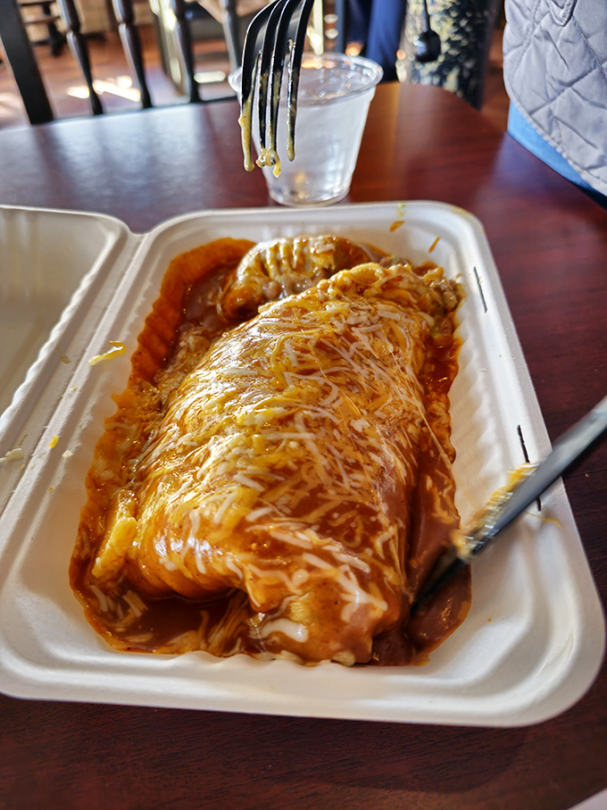 Behold the legendary green chili burrito in all its saucy glory. That melted cheese blanket is the food equivalent of a warm hug from your favorite aunt.