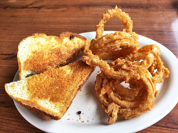 Golden-brown grilled cheese perfection meets crispy onion rings&mdash;a plate that whispers "diet tomorrow" but screams "happiness today."