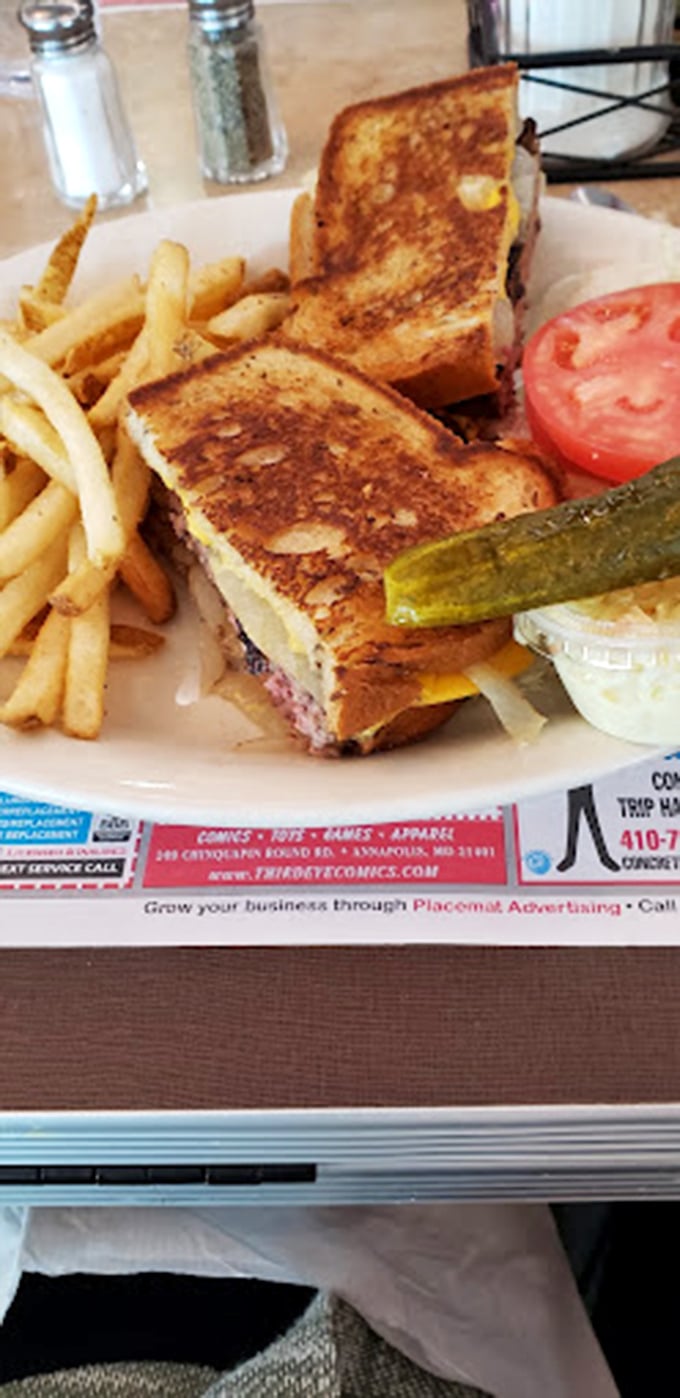 The holy trinity of diner perfection: golden-brown grilled cheese, crispy fries, and that obligatory pickle spear. Comfort food that speaks directly to your inner child.