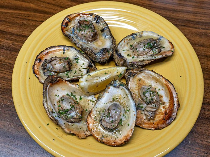 Grilled oysters sizzle with buttery perfection on a sunny plate, like little oceanic campfires waiting to warm your soul.