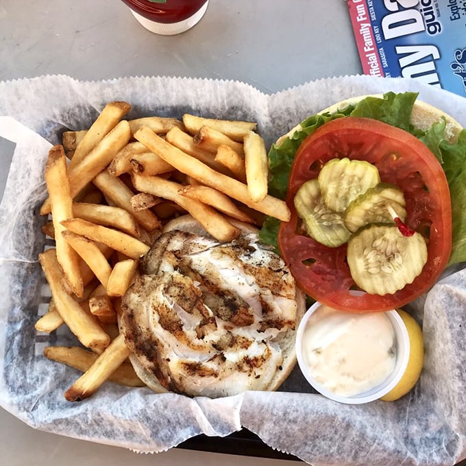 This grouper sandwich doesn't just satisfy hunger&mdash;it creates memories. Golden fries, fresh garnish, and that perfectly cooked fish deserve their own thank-you note.