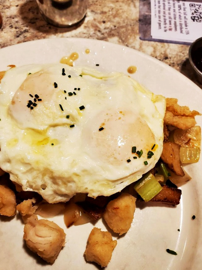 Breakfast alchemy at its finest: Perfectly cooked eggs crown a mountain of savory hash &ndash; the kind of morning meal that makes hitting snooze feel like a cardinal sin.