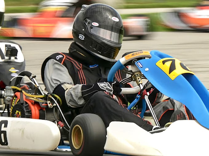 Behind every colorful helmet is someone living their racing fantasy. This driver's intense focus suggests breakfast cereal commercials aren't in their future.