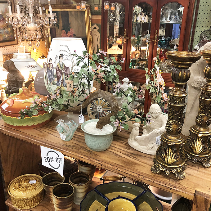 Curated chaos at its finest—porcelain figurines, ornate lamps, and decorative treasures create a still-life painting you can actually shop from.