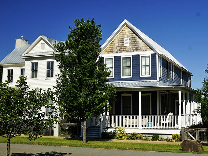 These aren't just houses; they're architectural love letters to front-porch living. The blue beauty and its neighbor practically whisper, "Slow down and stay awhile."
