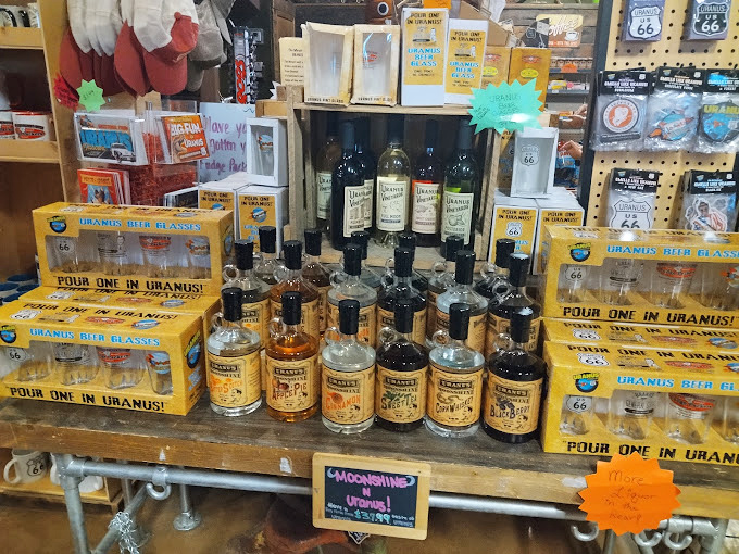 "Moonshine from Uranus" bottles line wooden shelves alongside clever drinking vessels. The store's astronomical wordplay extends even to their spirited offerings for the 21+ crowd.