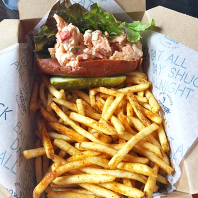 This lobster roll doesn't just sit on the plate—it commands attention. Golden fries stand at attention beside their seafood superior.v