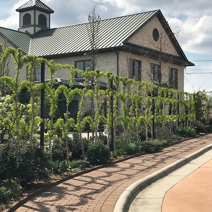 Espaliered greenery climbs the walls of this stately garden building&mdash;proof that even plants appreciate good real estate with a view.