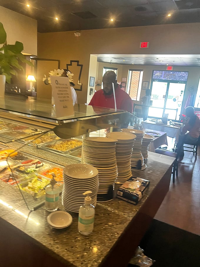 The buffet awaits with its steaming trays of Southern classics, where plates stack high and hungry customers survey their options like treasure hunters.