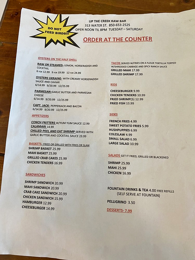 The menu reads like a love letter to the Gulf. Notice the "Do Not Feed Birds!!!" warning—a lesson someone clearly learned the hard way.