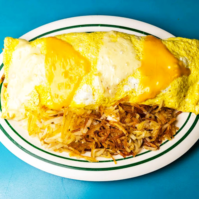 Behold the cheese omelet in its golden glory! Paired with crispy hash browns, it's the breakfast equivalent of a warm hug.