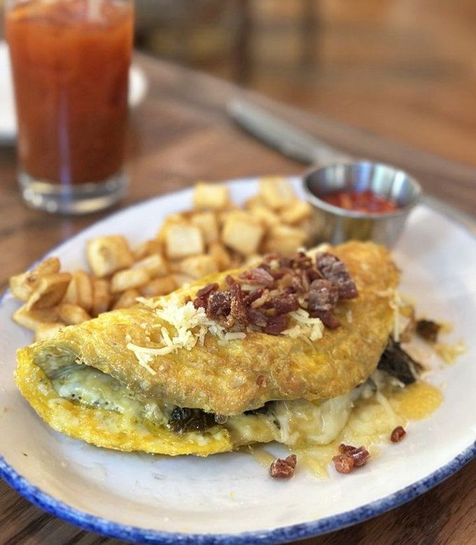 This omelet doesn't just sit on the plate&mdash;it lounges luxuriously, draped in cheese and crowned with bacon bits. Breakfast royalty.
