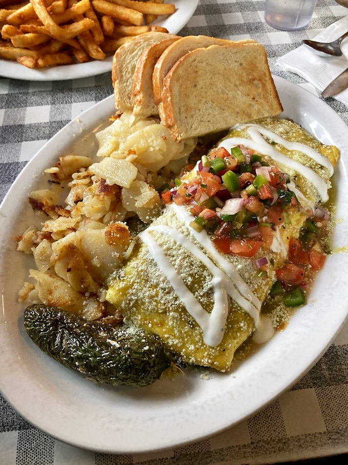 This isn't just an omelet; it's a morning masterpiece draped in salsa, crowned with avocado, and ready for its close-up. 