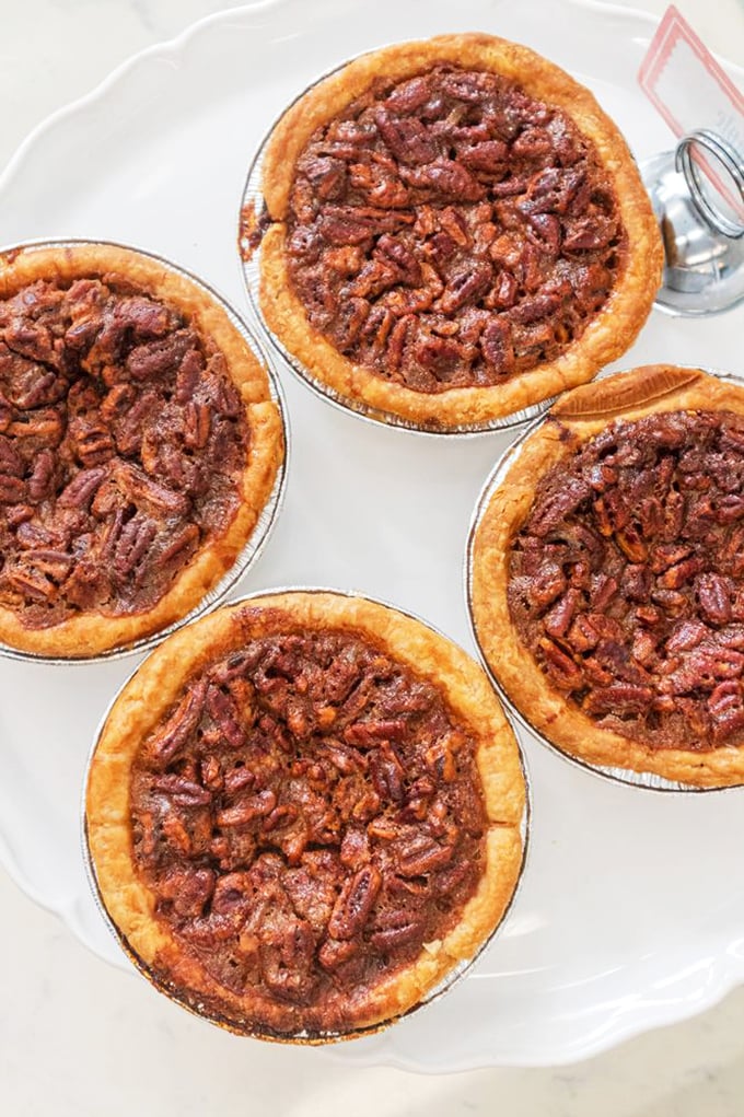 These mini pecan pies aren't just desserts, they're edible Georgia postcards&mdash;perfectly toasted pecans nestled in a caramel embrace that whispers, "Y'all come back now."